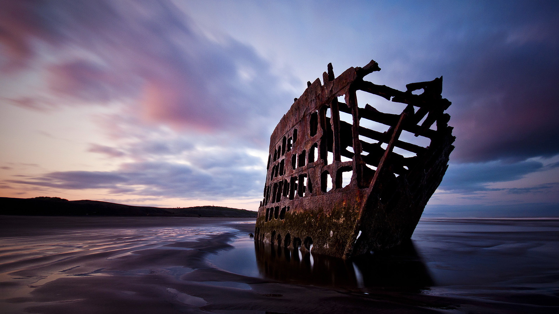 Silent Sentinel: The Timeless Shipwreck at Dusk