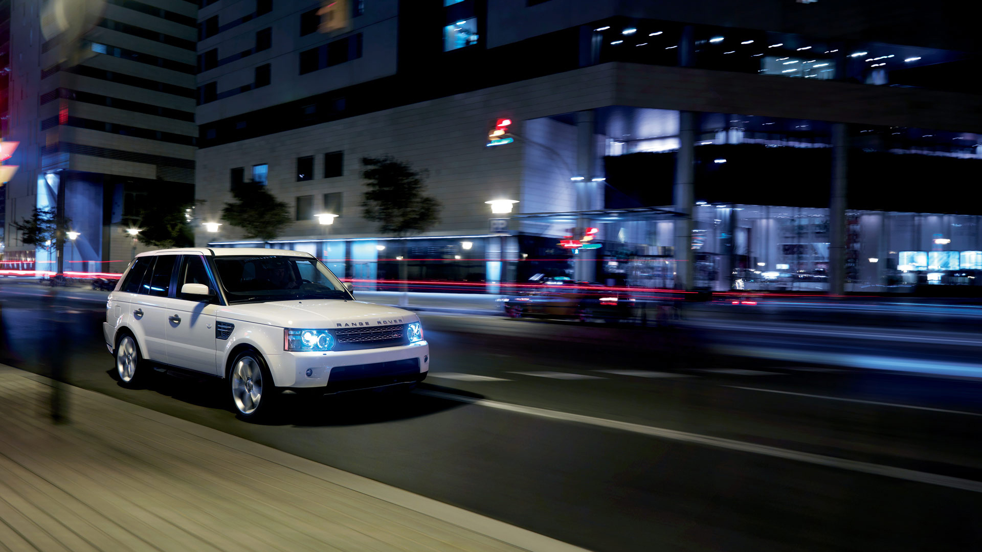 Urban Night Drive: Sleek Range Rover in Motion