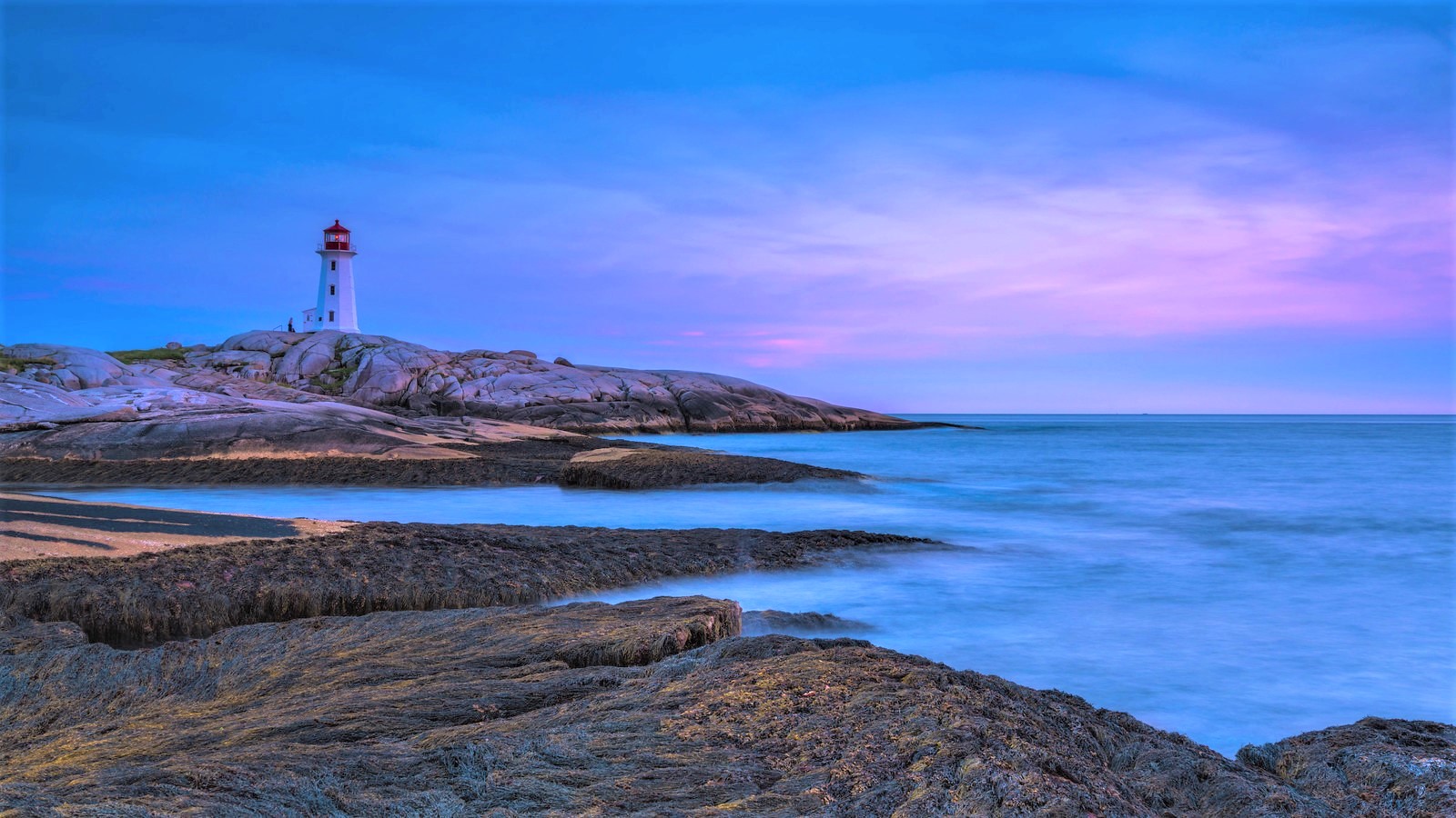 Tranquil Blue Waters and a Coastal Lighthouse