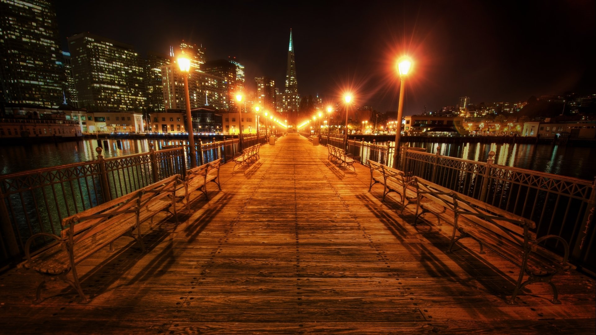 Illuminated Urban Pier Stretching into Night