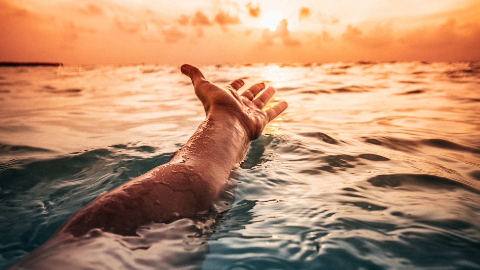 Hand Reaching Out in Ocean - Image Abyss