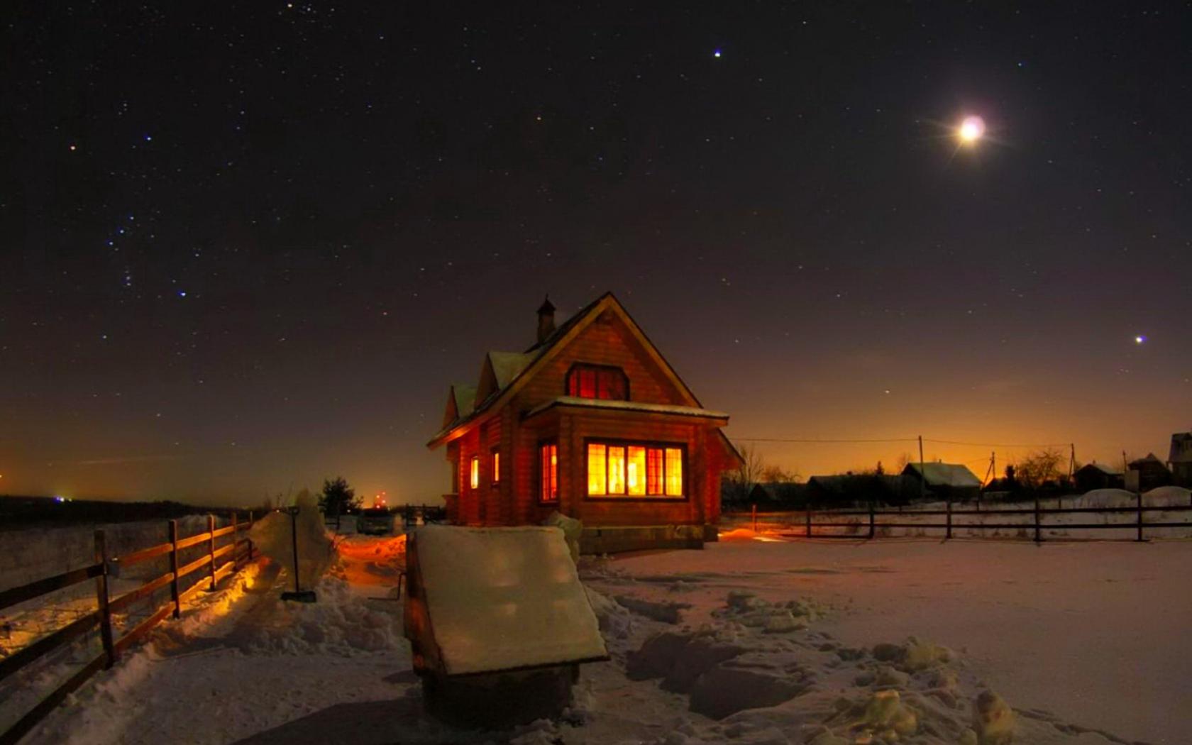 Winter Night Serenity: A Cozy House Amidst Snowy Landscapes
