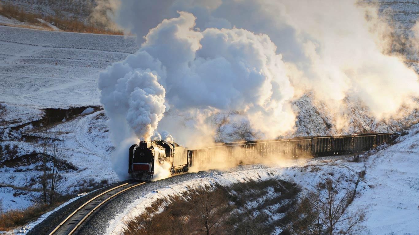 Majestic Train Journey Through Snowy Landscapes
